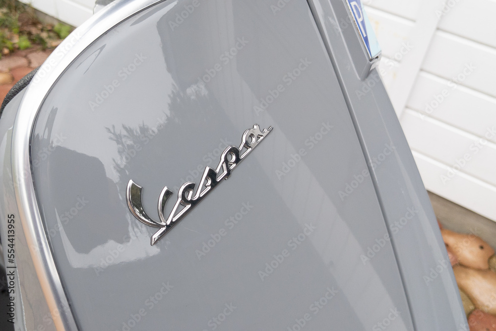 Vespa text sign and brand logo on front of grey gts vintage scooter ...