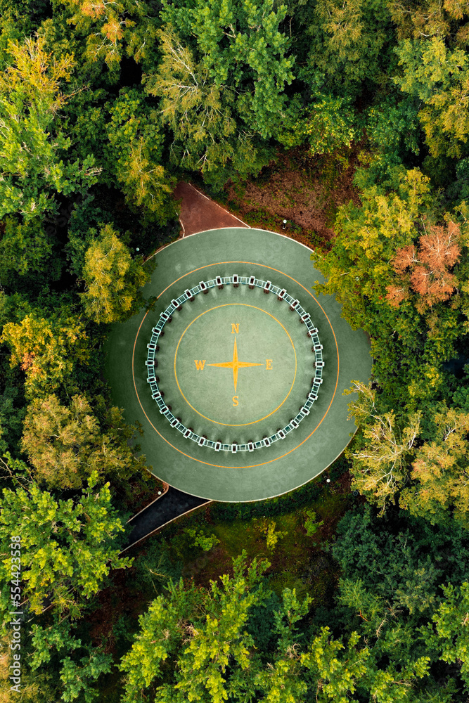 Aerial top view of Rose of Wind sign in city park. Emblem star compass ...