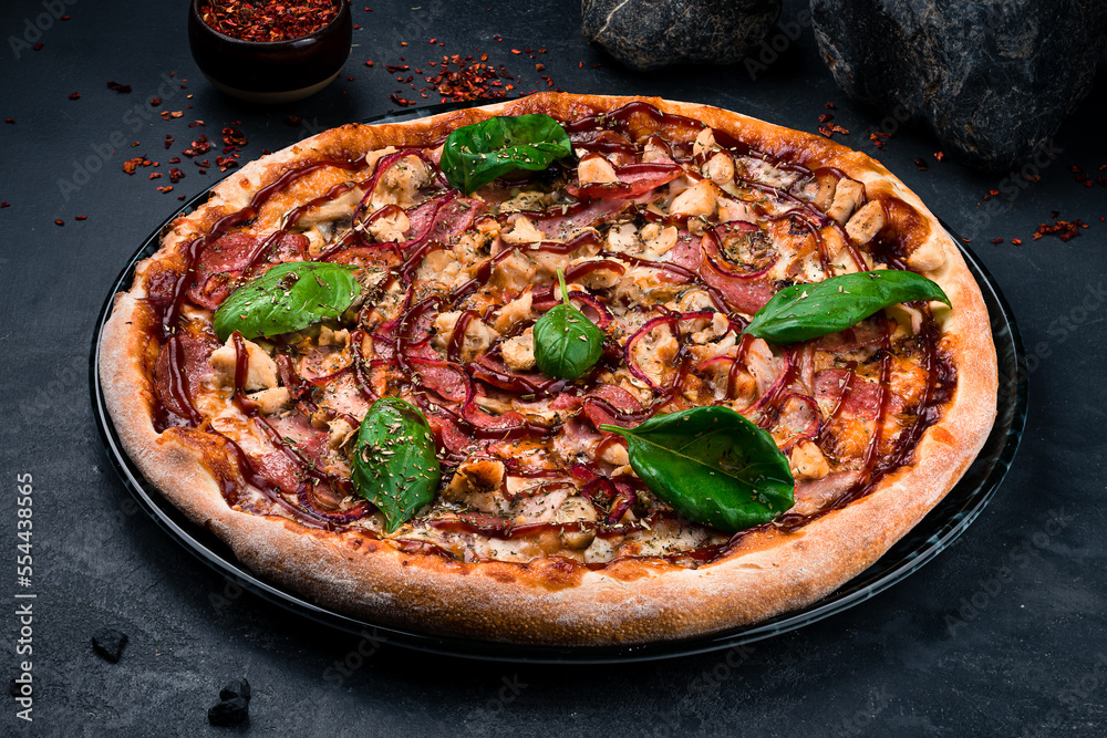 Barbecue pizza with chicken fillet, salami, brisket, barbecue sauce ...