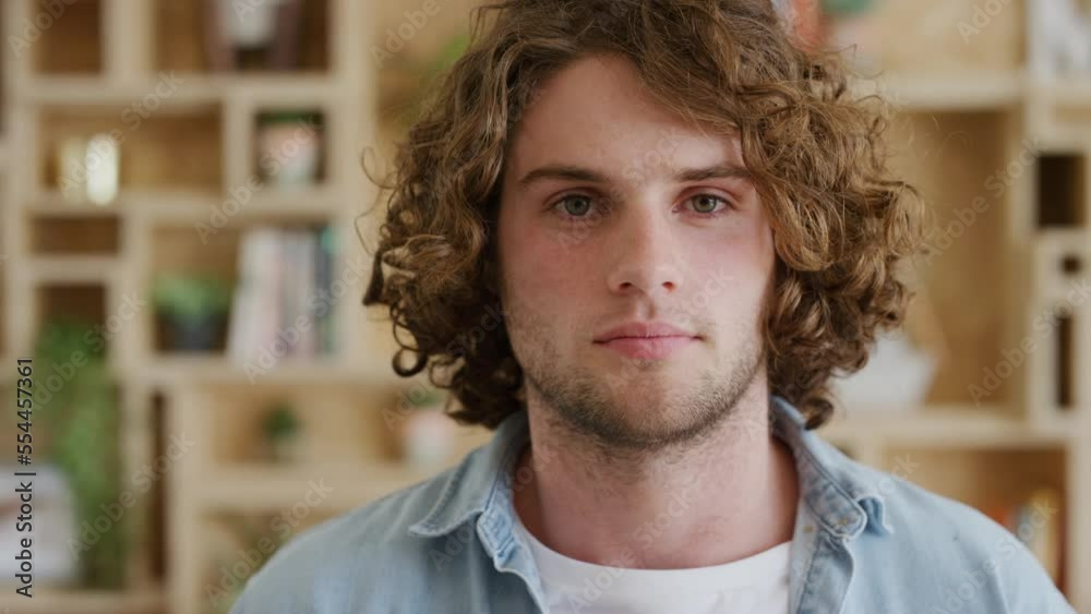 Face, front and man with curly hair on creative office background for ...