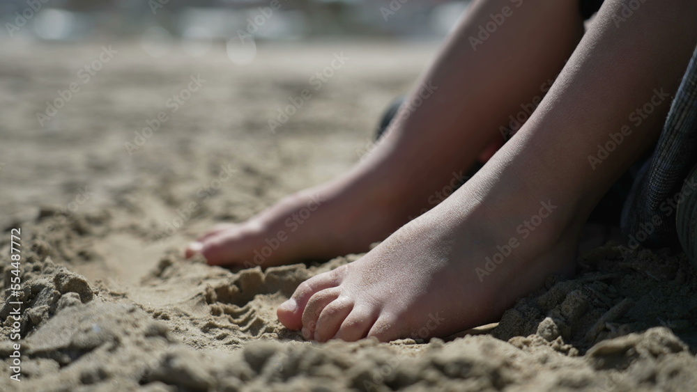 Child feet standing up at beach feeling the sand barefoot. Kid foot ...