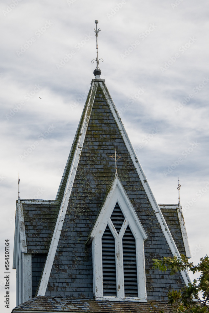 A vintage royal blue color wooden church roof with white trim. The ...