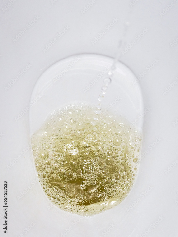 The lavatory in the toilet and the stream of urine during urination ...