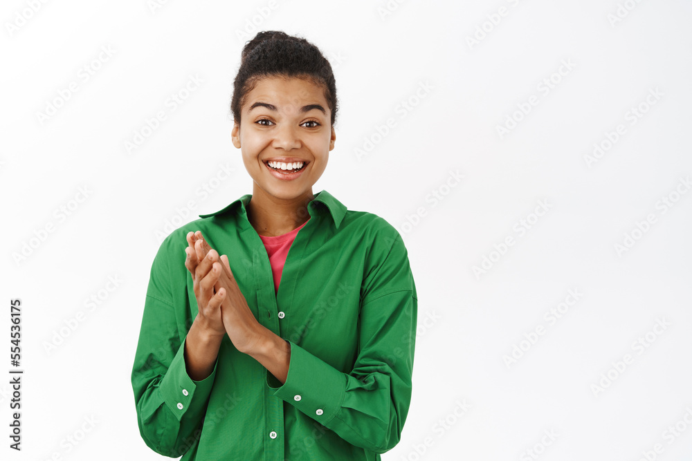 Bravo. Smiling african american girl, claps hands, applause and looks ... Bravo. Smiling african american girl, claps hands, applause and looks ...