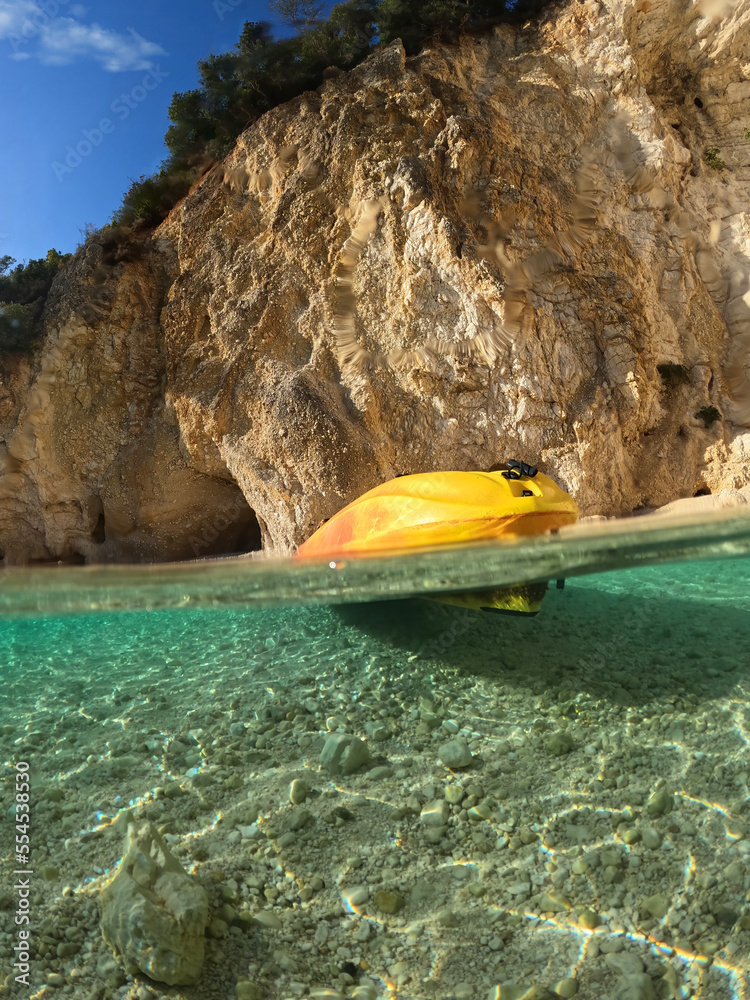 Underwater split photo of sport canoe in crystal clear emerald sea and ...