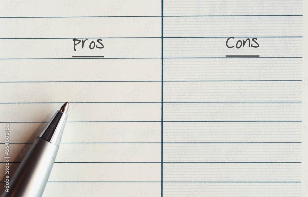 A silver pen on a line note paper with two choices to choose between ...