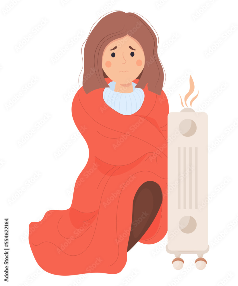 Cute girl wrapped in blanket is freezing and basking near hot radiator ...