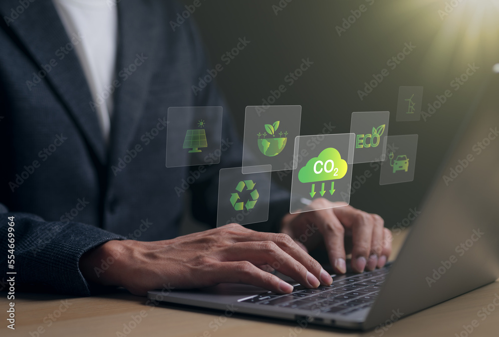 Reduce CO2 emission concept. Businessman using laptop for working ...