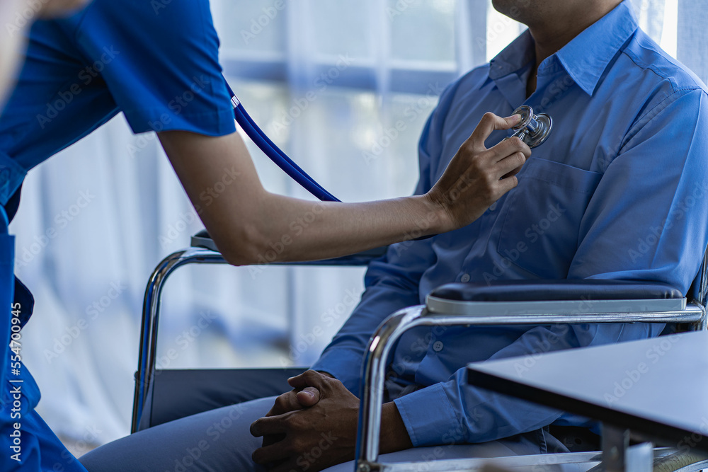 Female doctor measuring heart rate of male patient at hospital at ...