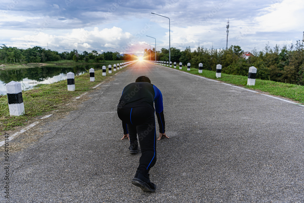 Male runner prepares to run on the road to ambition. Start over with ...