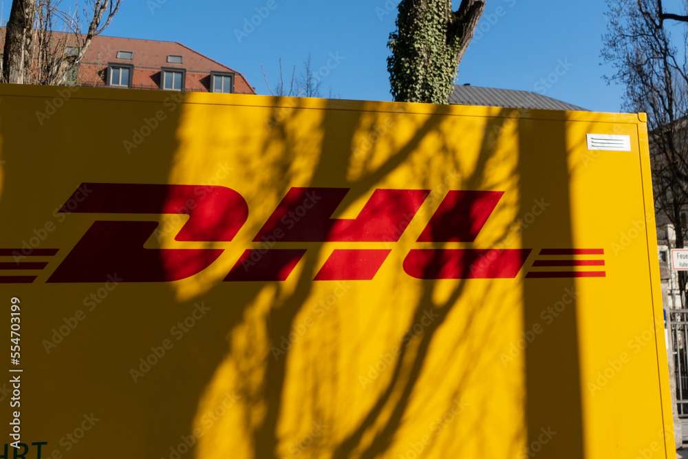 DHL parcel truck from the side with logo in the evening sun on Stock ...