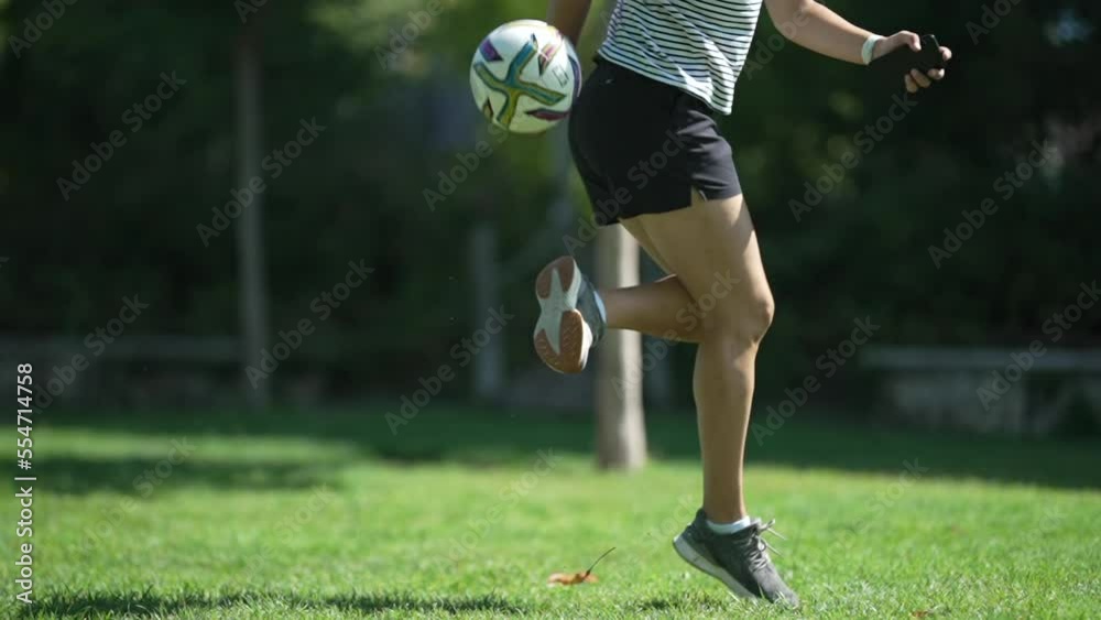 Female soccer player doing rainbow trick outdoors. Person doing sport ...