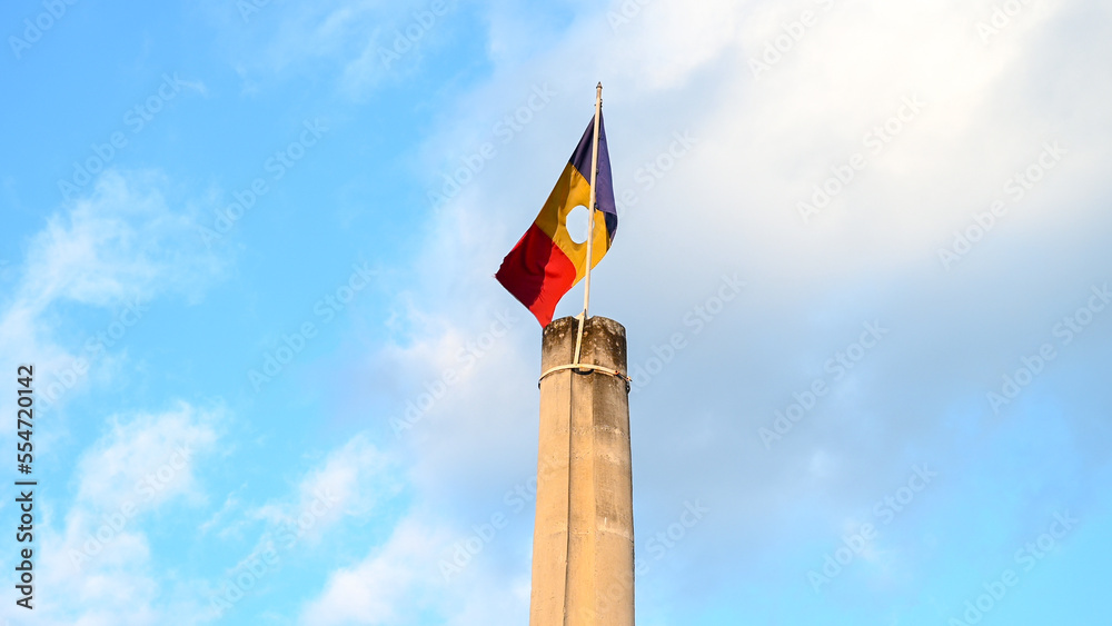 The Flag of the Romanian Revolution on monument. Romanian flags with ...