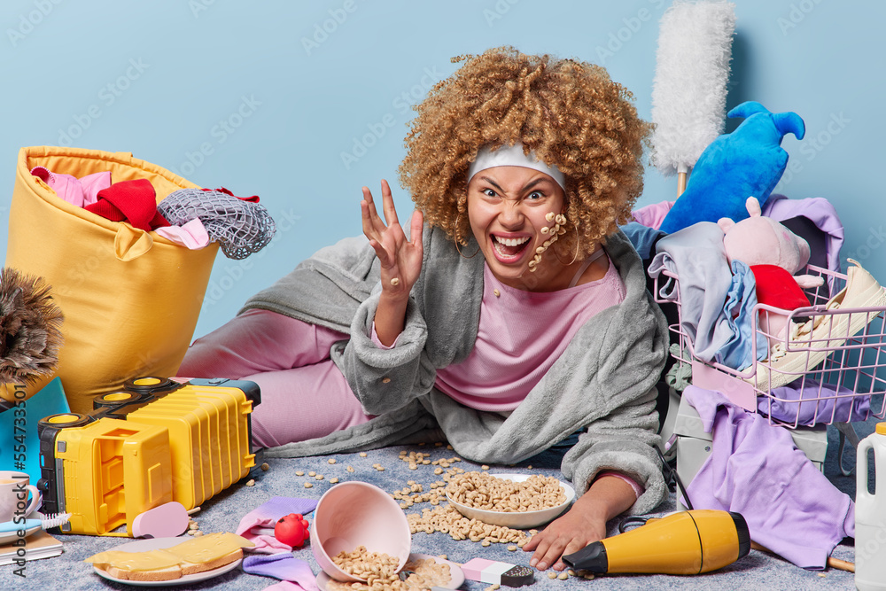 Crazy emotional woman with curly hair gestures and screams angrily ...