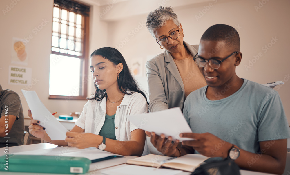 Student, exam and woman teacher with students in a school education ...