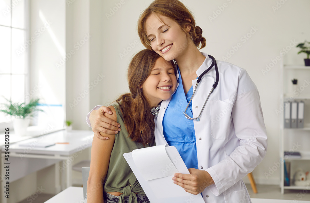Happy doctor hugging child patient. Happy beautiful pediatrician in ...