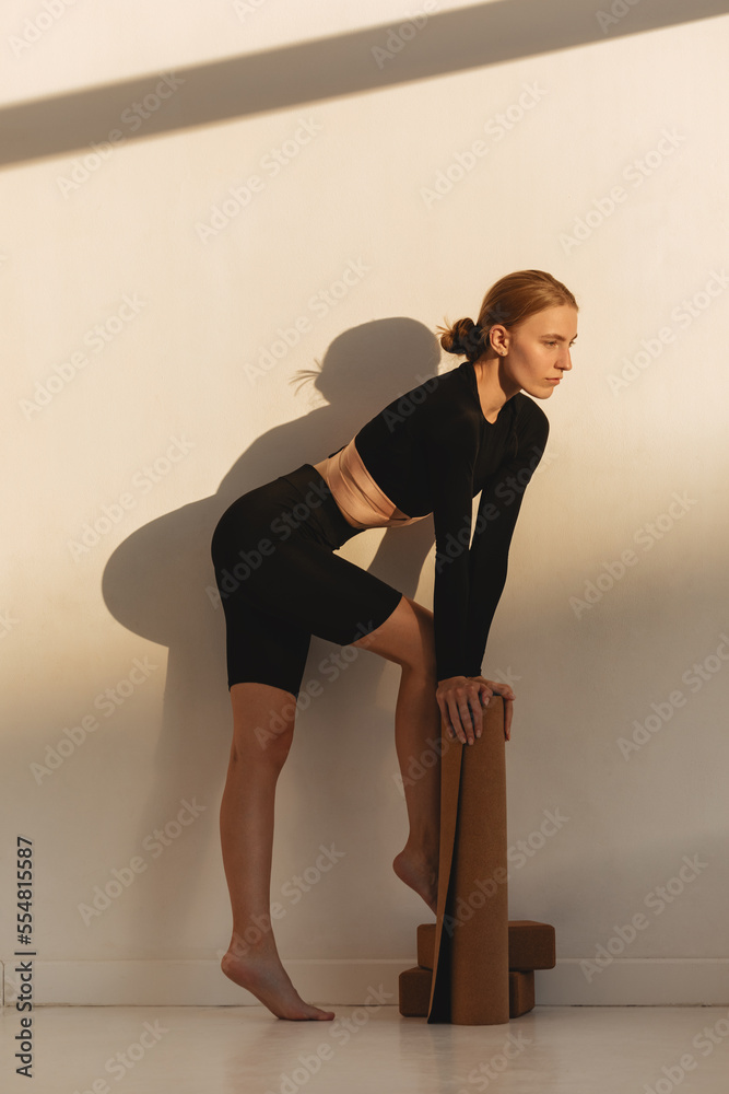 Wellness exercise, woman on floor mat stretching alone, workout day ...