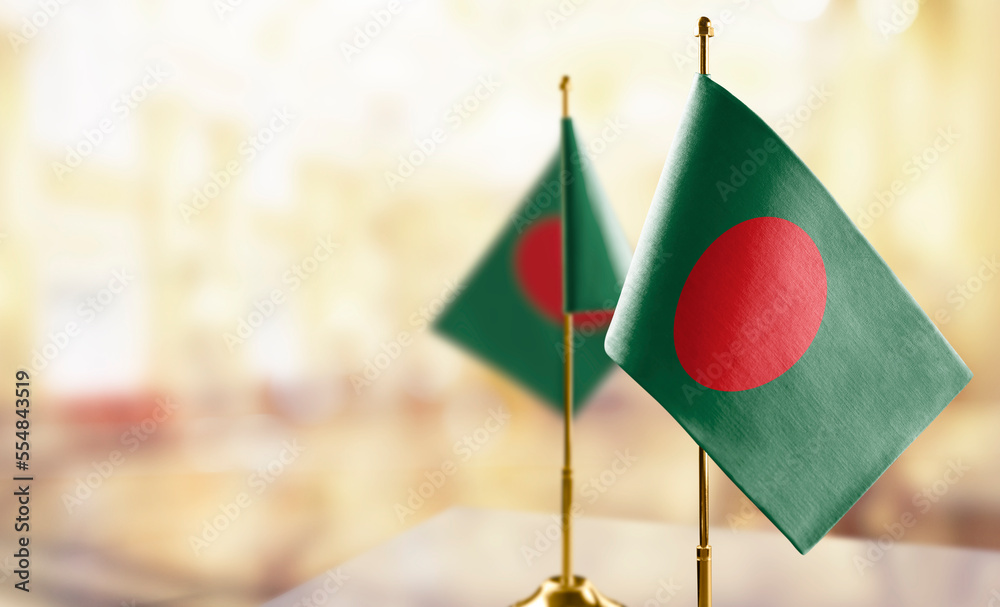 Small flags of the Bangladesh on an abstract blurry background foto de ...