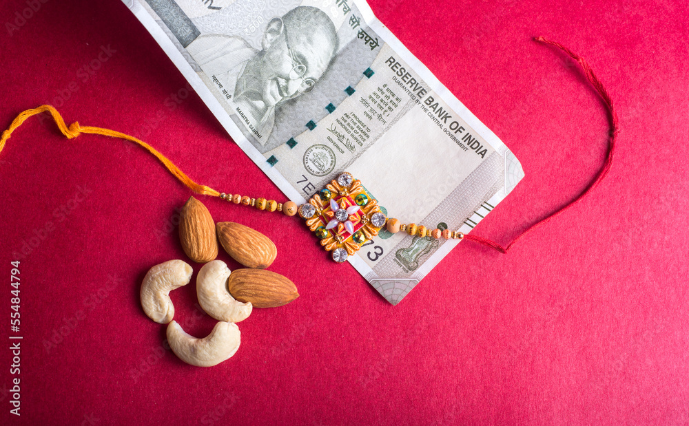 Indian traditional Festival Rakhi with rice grains, kumkum and gift ...