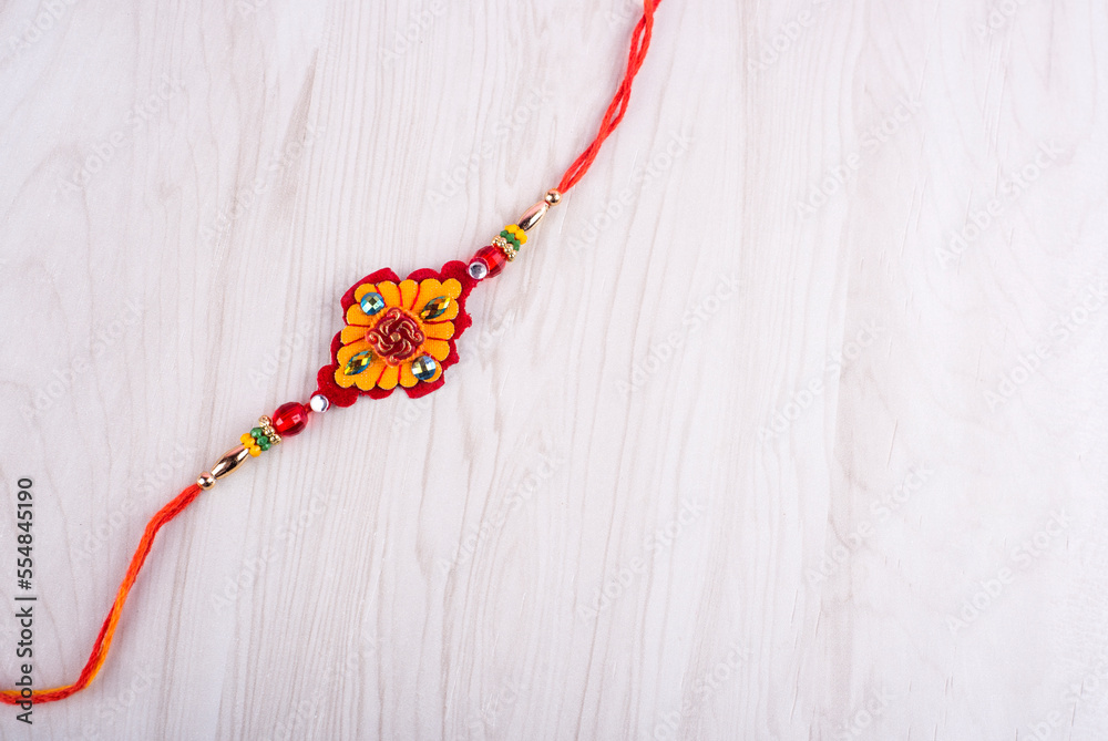 Indian traditional Festival Rakhi with rice grains, kumkum and gift ...