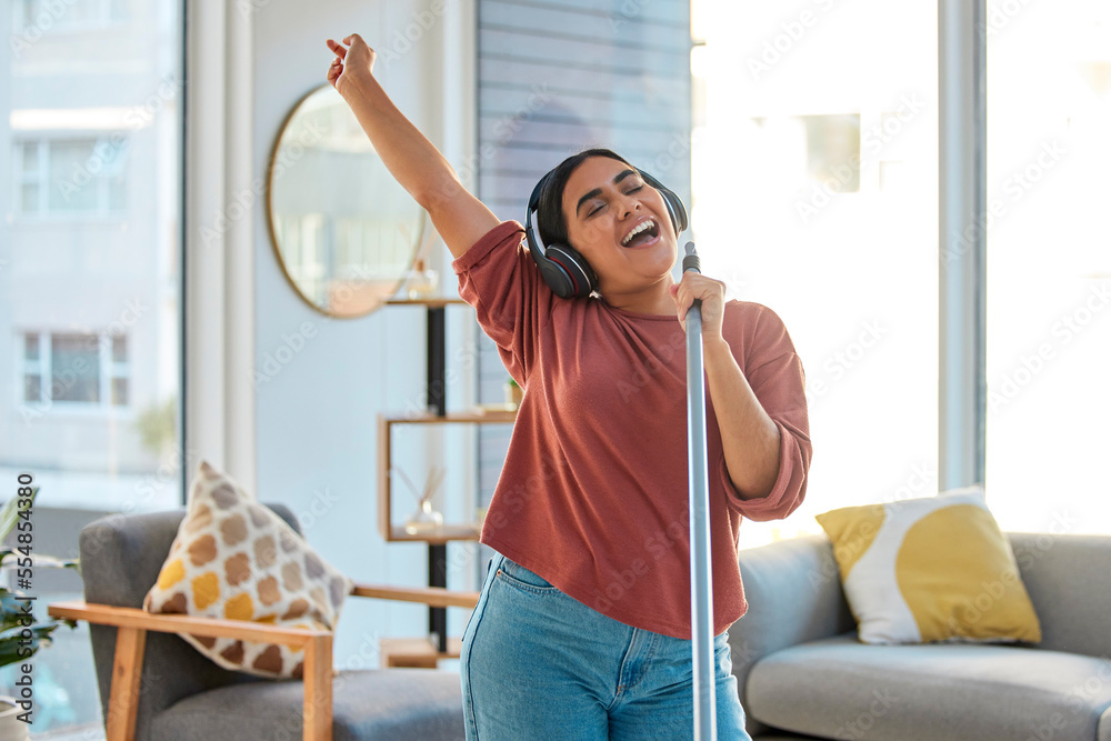 Music, headphones and woman singing while cleaning home, dancing and ...