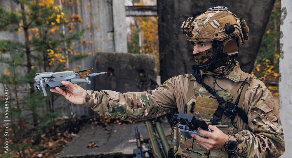 Modern army soldiers using aerial drone for artillery guidance and ...