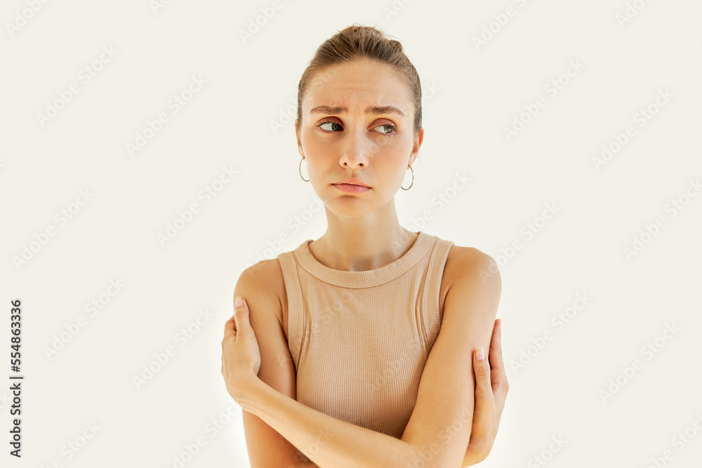 Beautiful sad girl hugging herself, giving herself support and ...