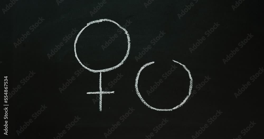 Symbols of male and female gender drawn in chalk on the blackboard ...