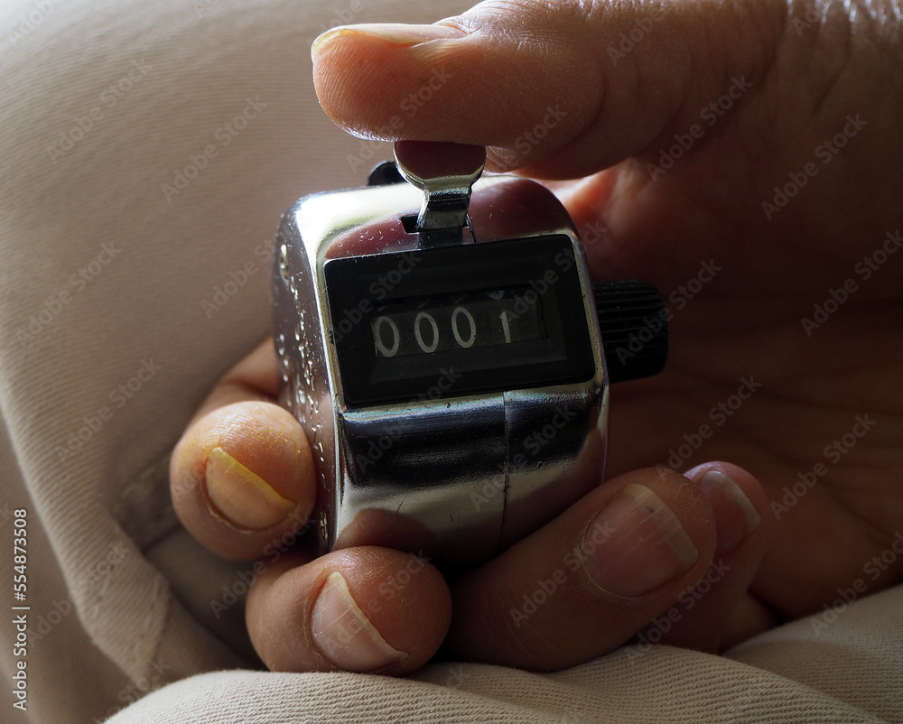 Manual counter with 0001 on its screen. Handheld counting machine ...