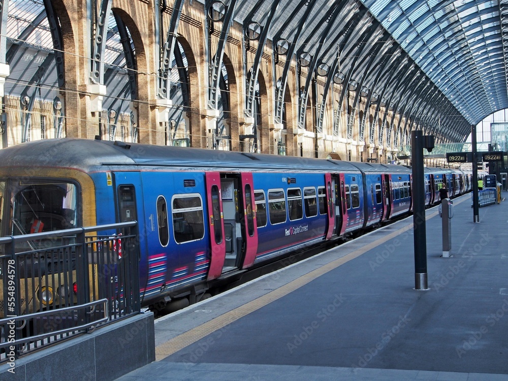 Railway station platform with glass roof, King's Cross, London, England ...