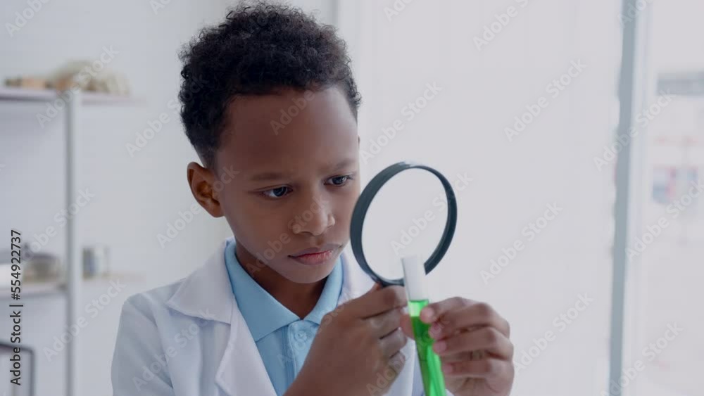 4K, school kid boy, studying science, held magnifying glass point glass ...