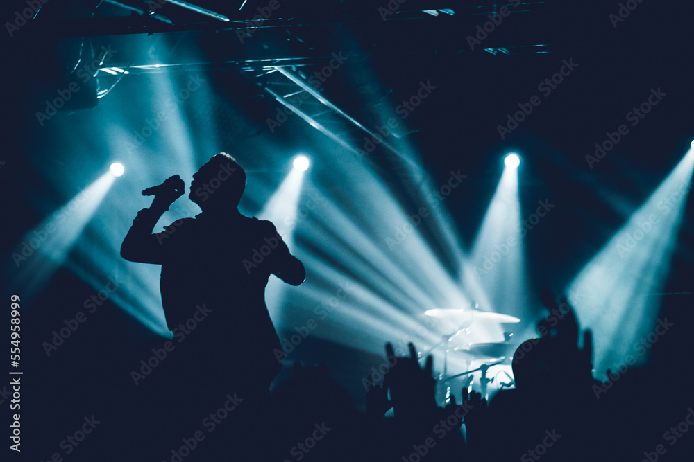 Rock singer on scene in club. Bright stage lighting. Band Blue ...