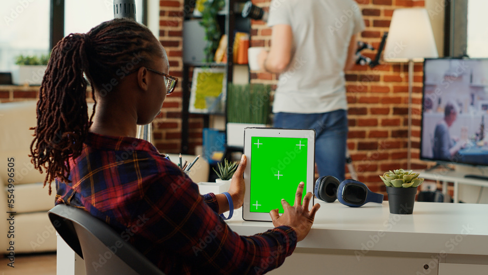 Office employee analyzing digital tablet with greenscreen display ...