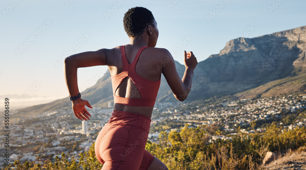 Back, black woman and running in nature, workout and training for ...
