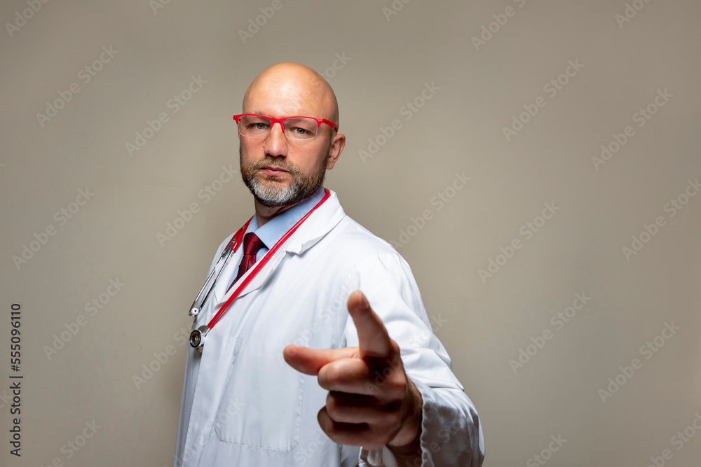 Portrait of a bald male doctor wearing white uniform and red ...