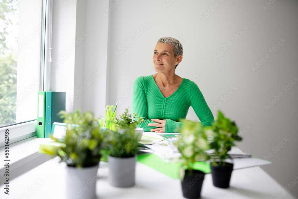 Landscape architect, garden architect is sitting in her modern green ...