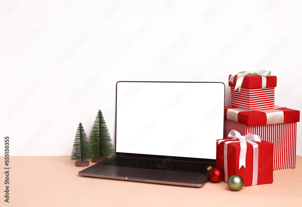 Blank screen on laptop for mock up. Christmas festival setup with gift ...