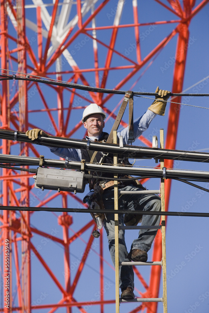Cable lineman climbing a ladder to repair transmission line Stock Photo ...