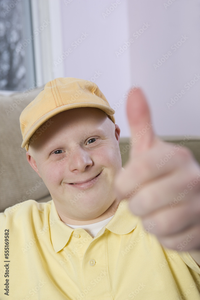 Man with Down Syndrome showing Thumbs Up sign Stock Photo | Adobe Stock