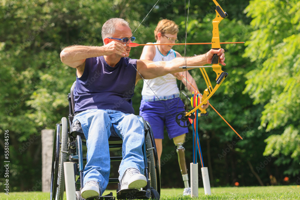 Man with spinal cord injury and woman with prosthetic leg during ...