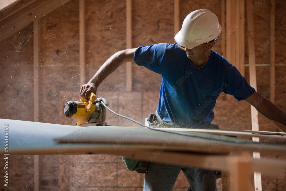 Carpenter using a circular saw Stock Photo | Adobe Stock