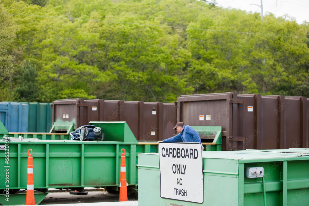 Engineer arranging cardboard at Cardboard Only recycling compactor ...