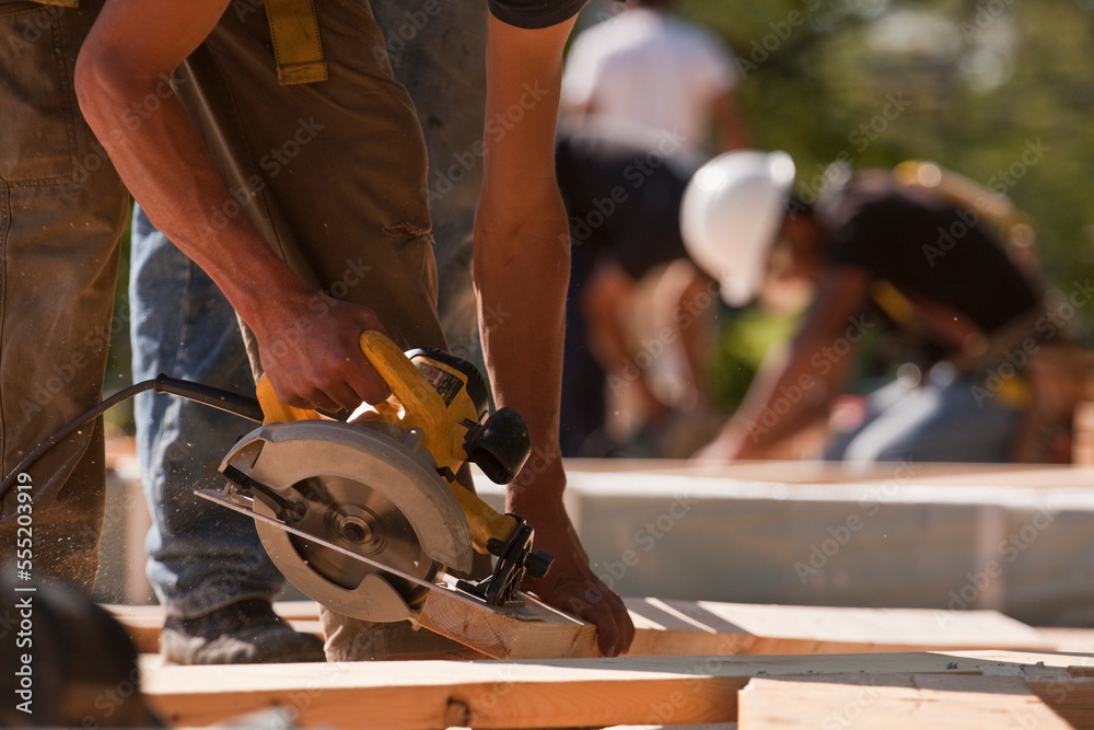 Carpenters using circular saw at a construction site Stock Photo ...
