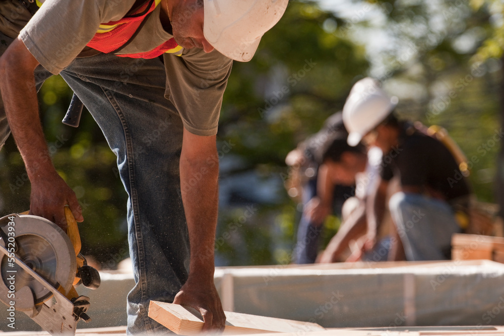 Carpenters using circular saw at a construction site Stock Photo ...