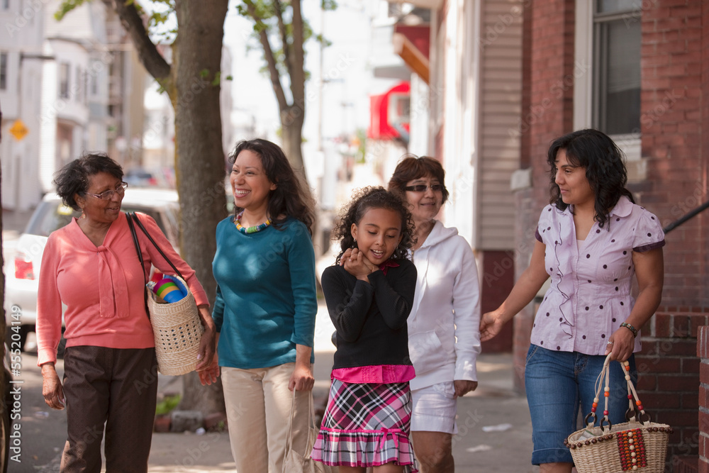 Women from three generations spend time together walking down a ...