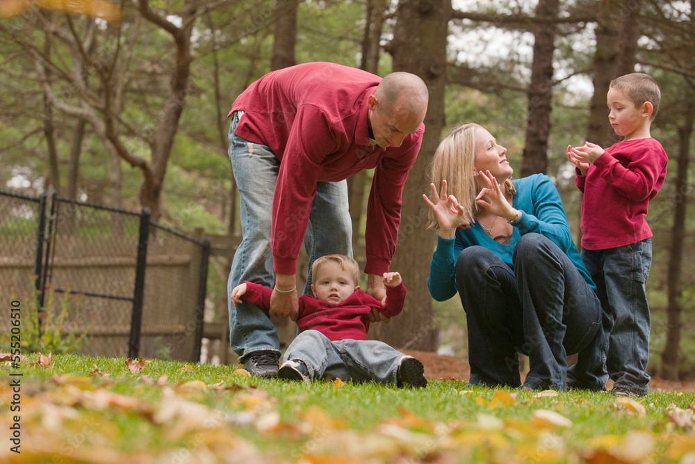 Woman signing the word 'Family' in American Sign Language while playing ...