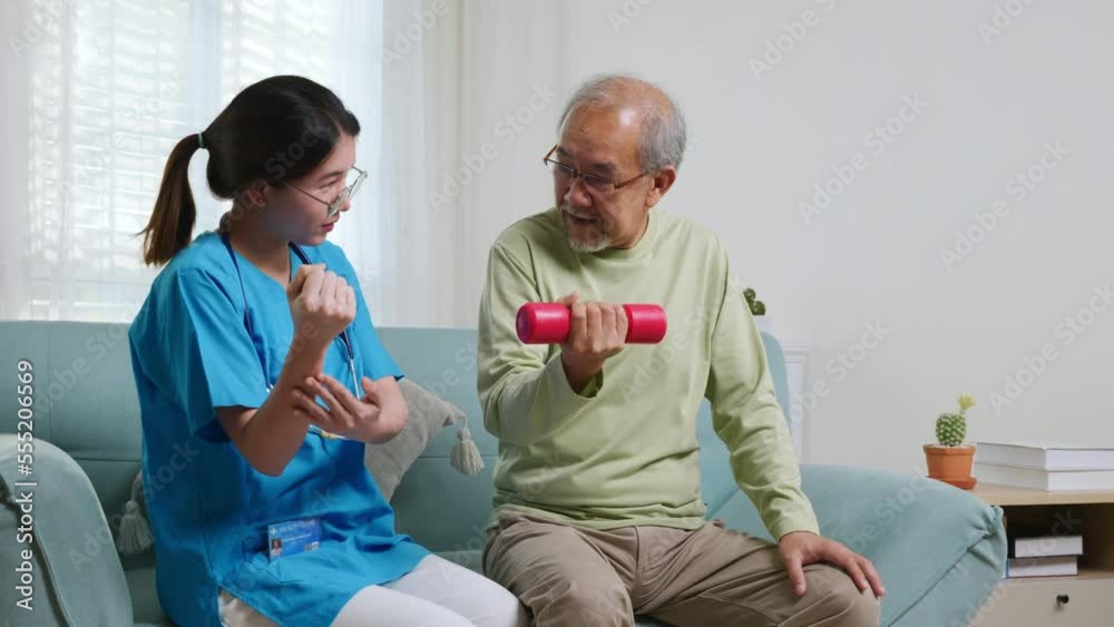 Young nurse physiotherapist helping old man in lifting dumbell at home, Asia nurse support ...