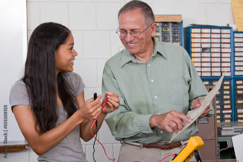 Engineering professor showing a resistor value chart to a student Stock ...