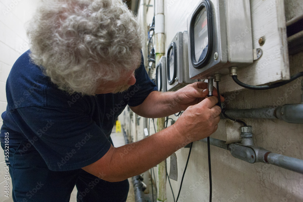 Engineer connecting O2 electrochemical sensor probe cable to meter in ...