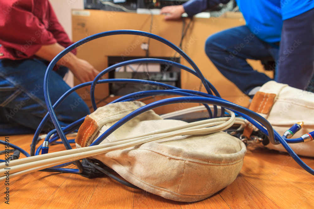 Cable installer showing home owner how to simplify cable routing Stock ...